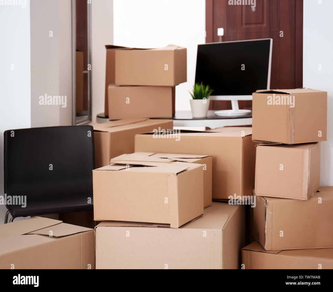 Carton boxes with stuff in room. Office move concept Stock Photo - Alamy