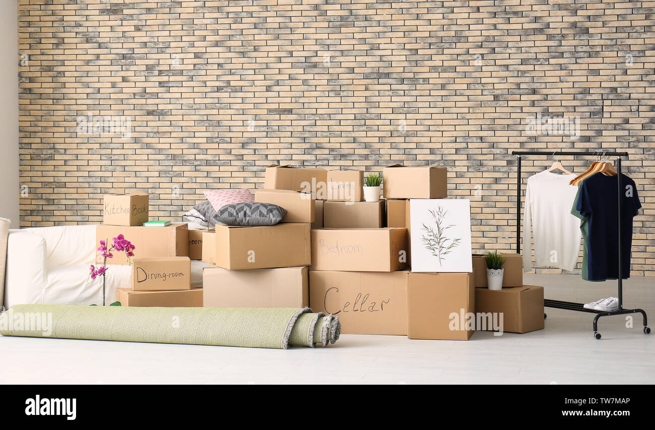 Carton boxes with stuff in room. Moving house concept Stock Photo - Alamy
