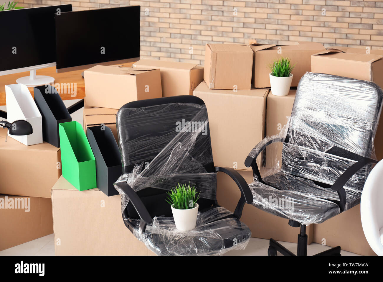 Carton boxes with stuff in room. Office move concept Stock Photo - Alamy
