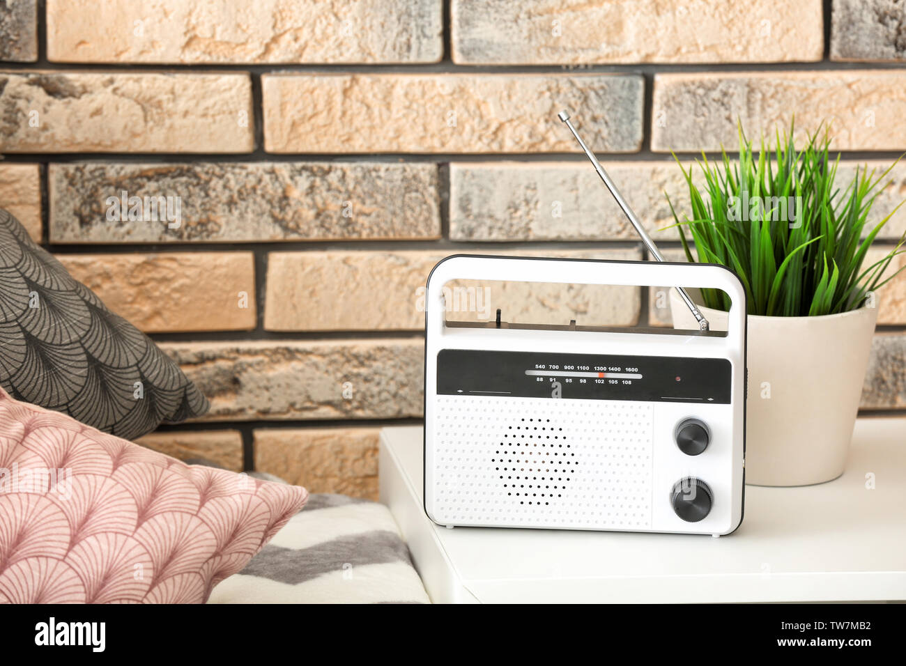 Retro radio on table against brick wall Stock Photo - Alamy