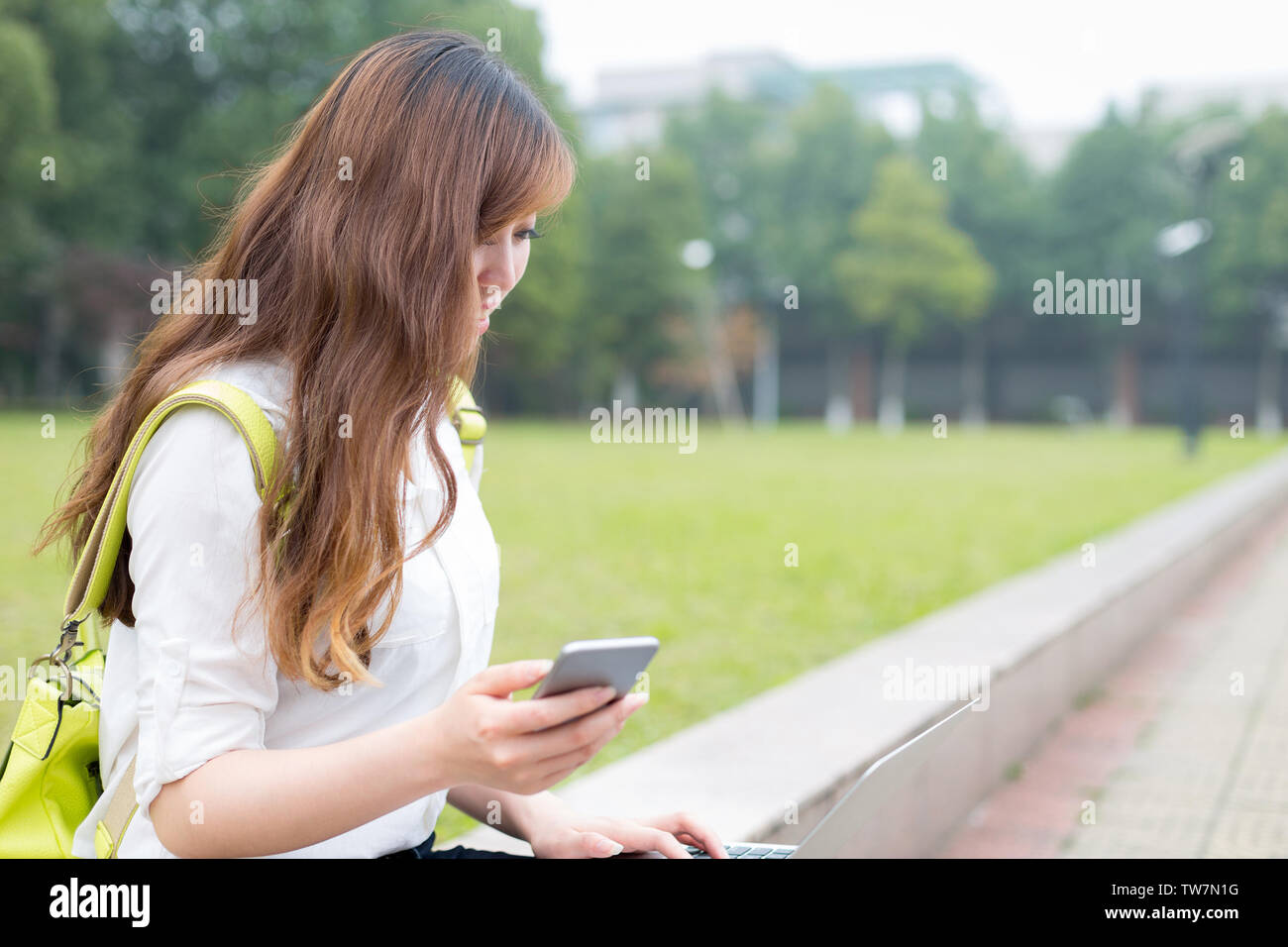 Asian beautiful female studen using mobile phone in campus Stock Photo ...