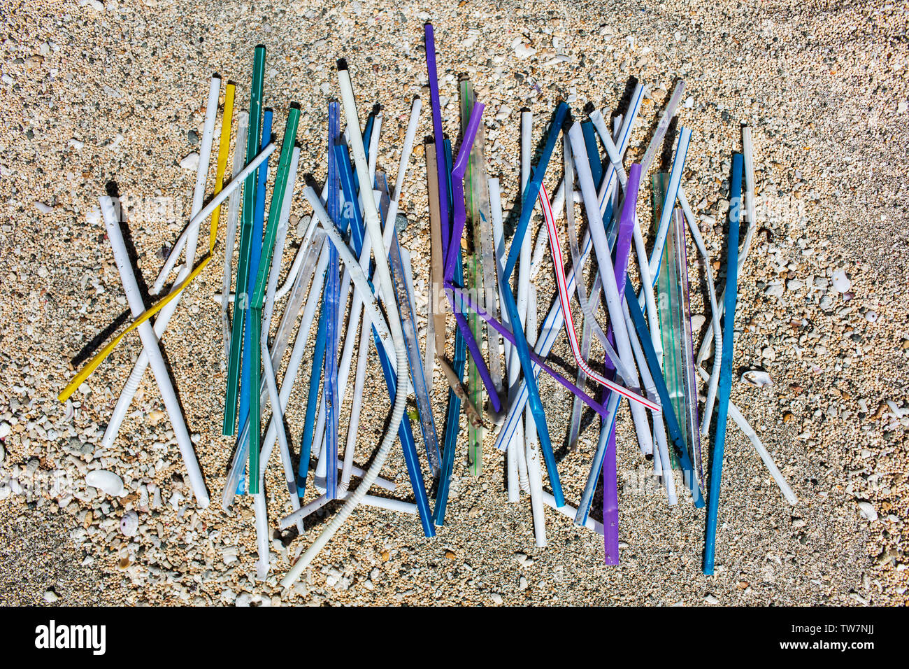 Heap of different multicolor plastic straws collected on the beach on ...
