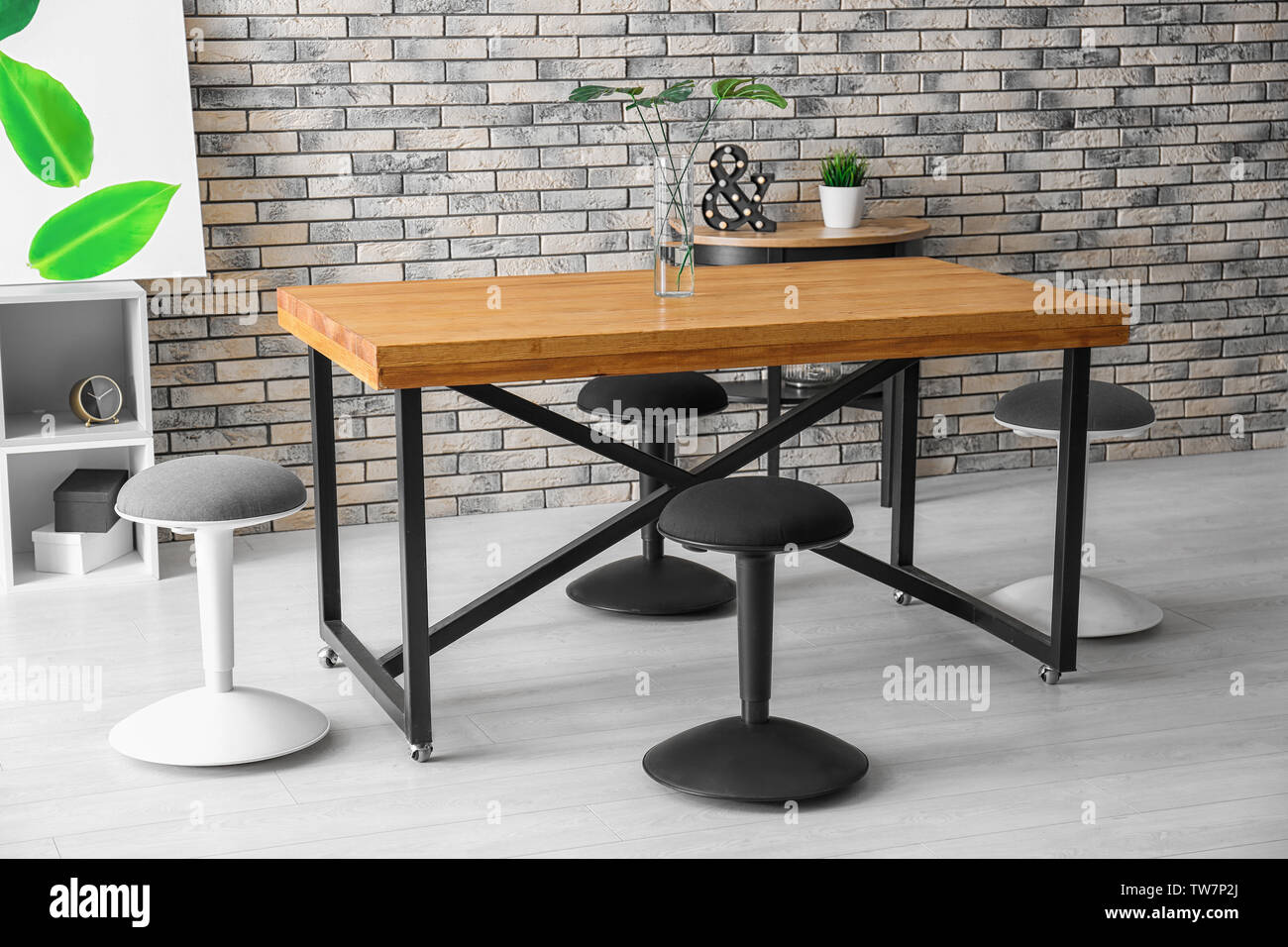 Modern room interior with table and stools Stock Photo - Alamy
