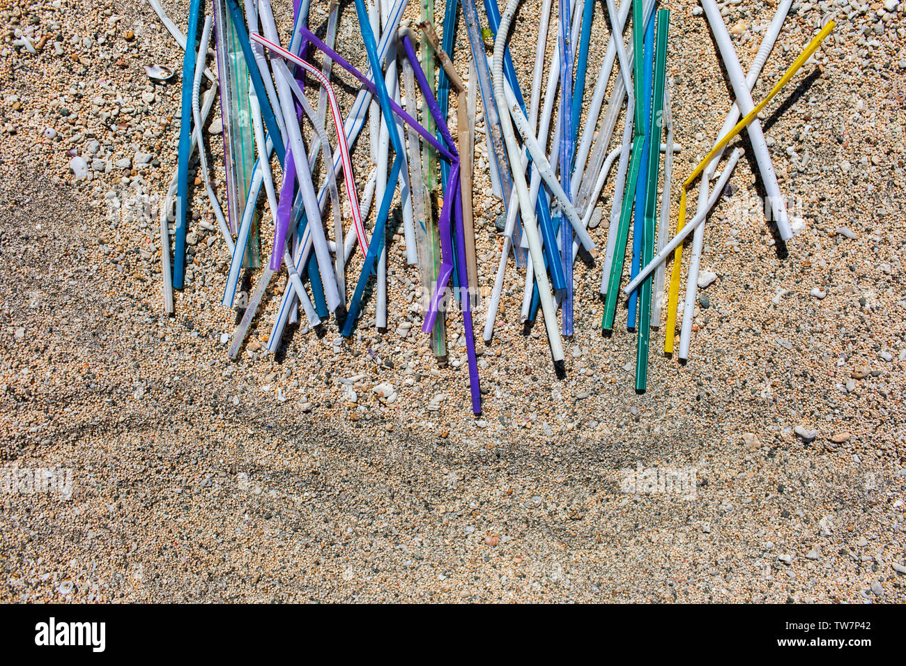 Heap of different multicolor plastic straws collected on the beach on ...
