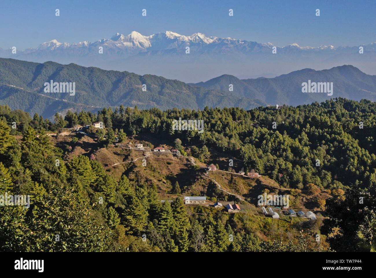 Homes and greenhouses in the foothills of the Himalaya mountain range ...