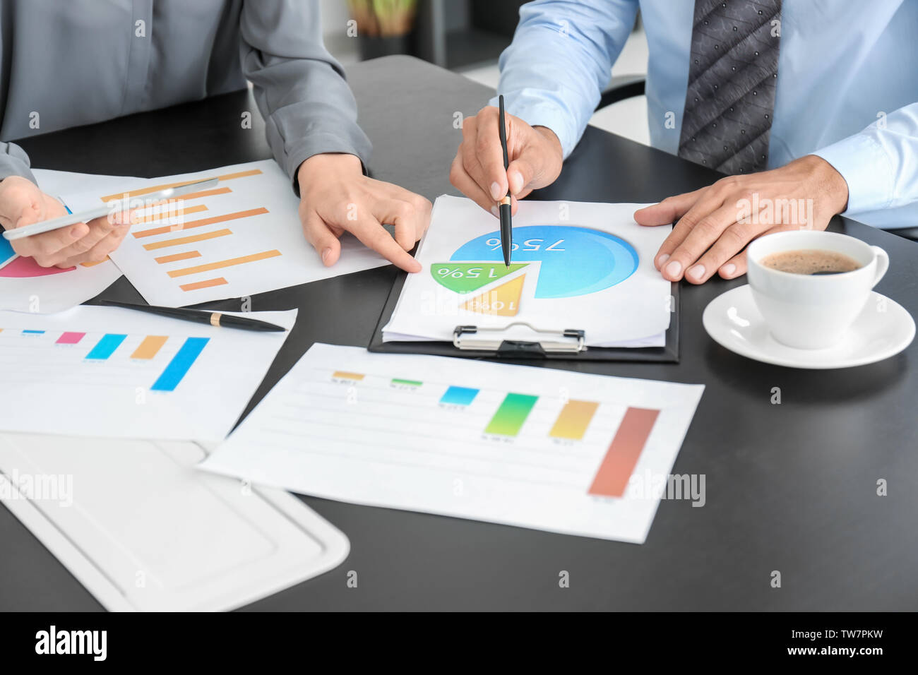 Office employees working with documents at desk Stock Photo - Alamy