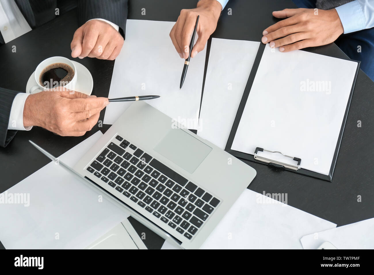 Office employees working with documents at desk Stock Photo - Alamy