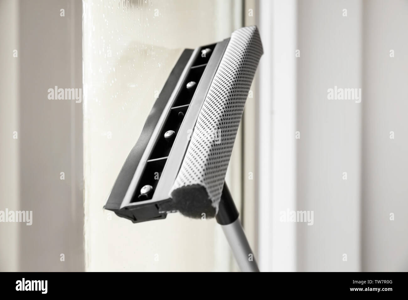 Cleaning window with squeegee, closeup Stock Photo - Alamy