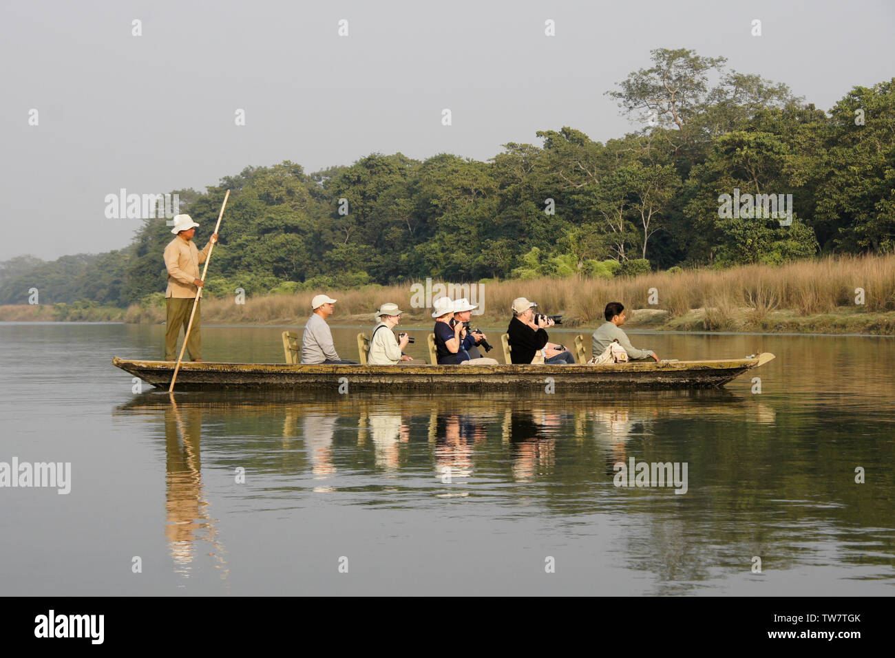 Tourists and their cameras enjoy a boat safari on the Rapti River in ...