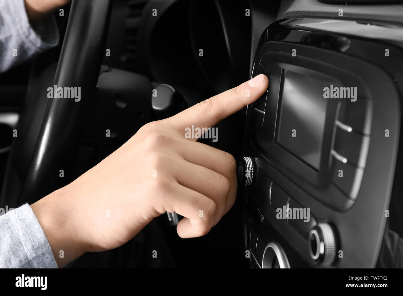 Man tuning radio in car Stock Photo - Alamy