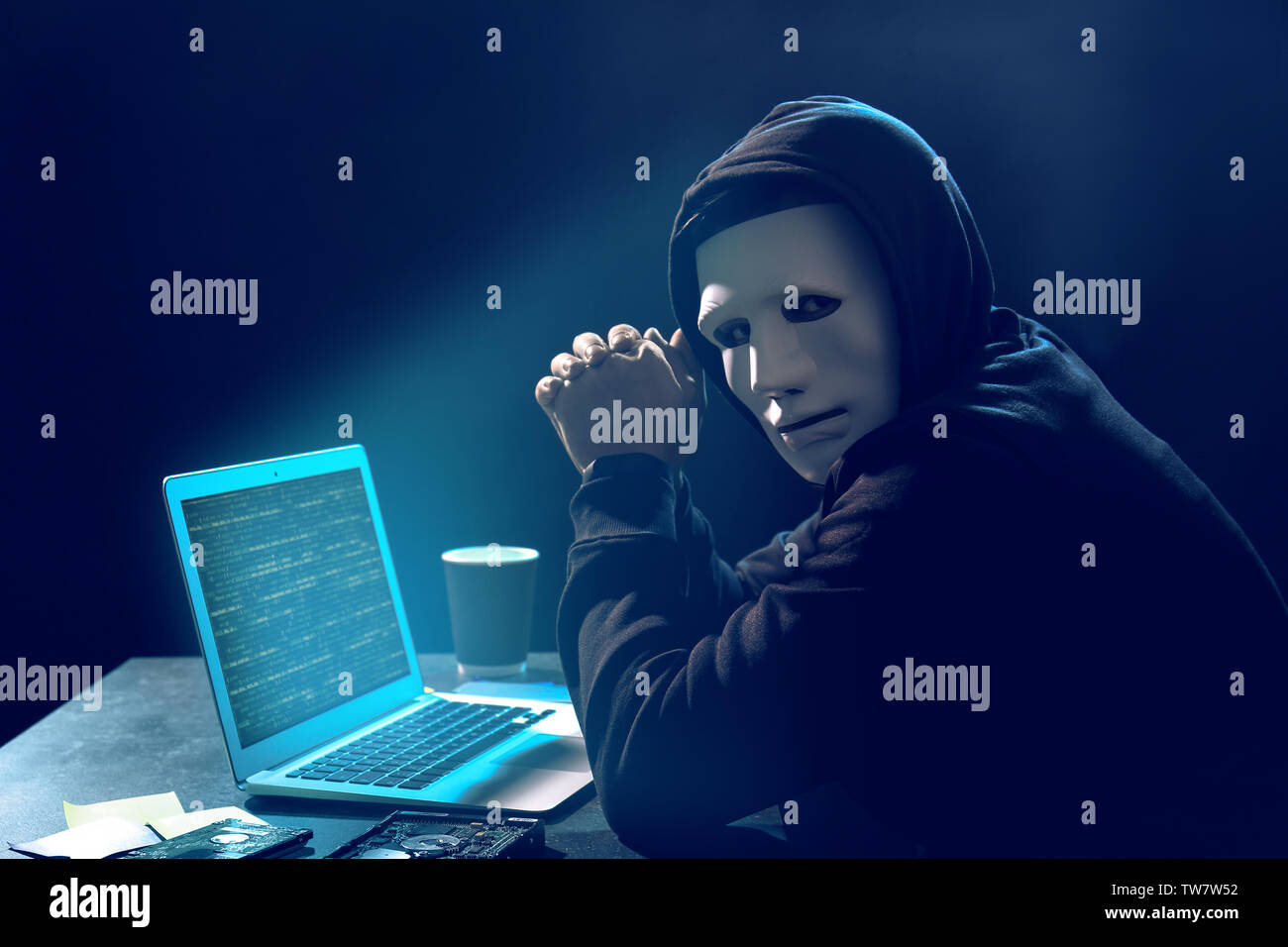 Hacker anonymous mask using laptop hi-res stock photography and images ...