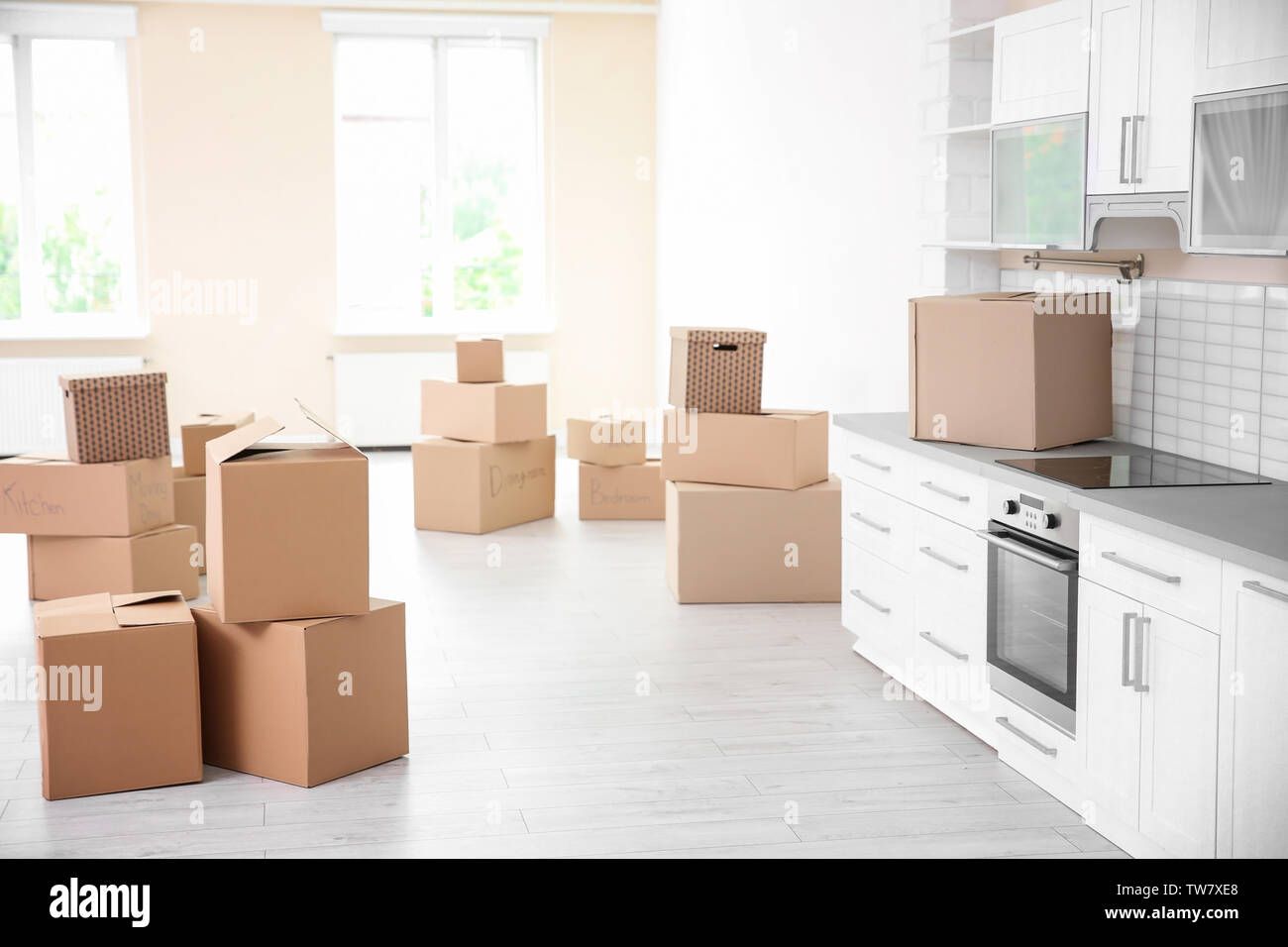 Cardboard boxes in kitchen of new apartment Stock Photo - Alamy