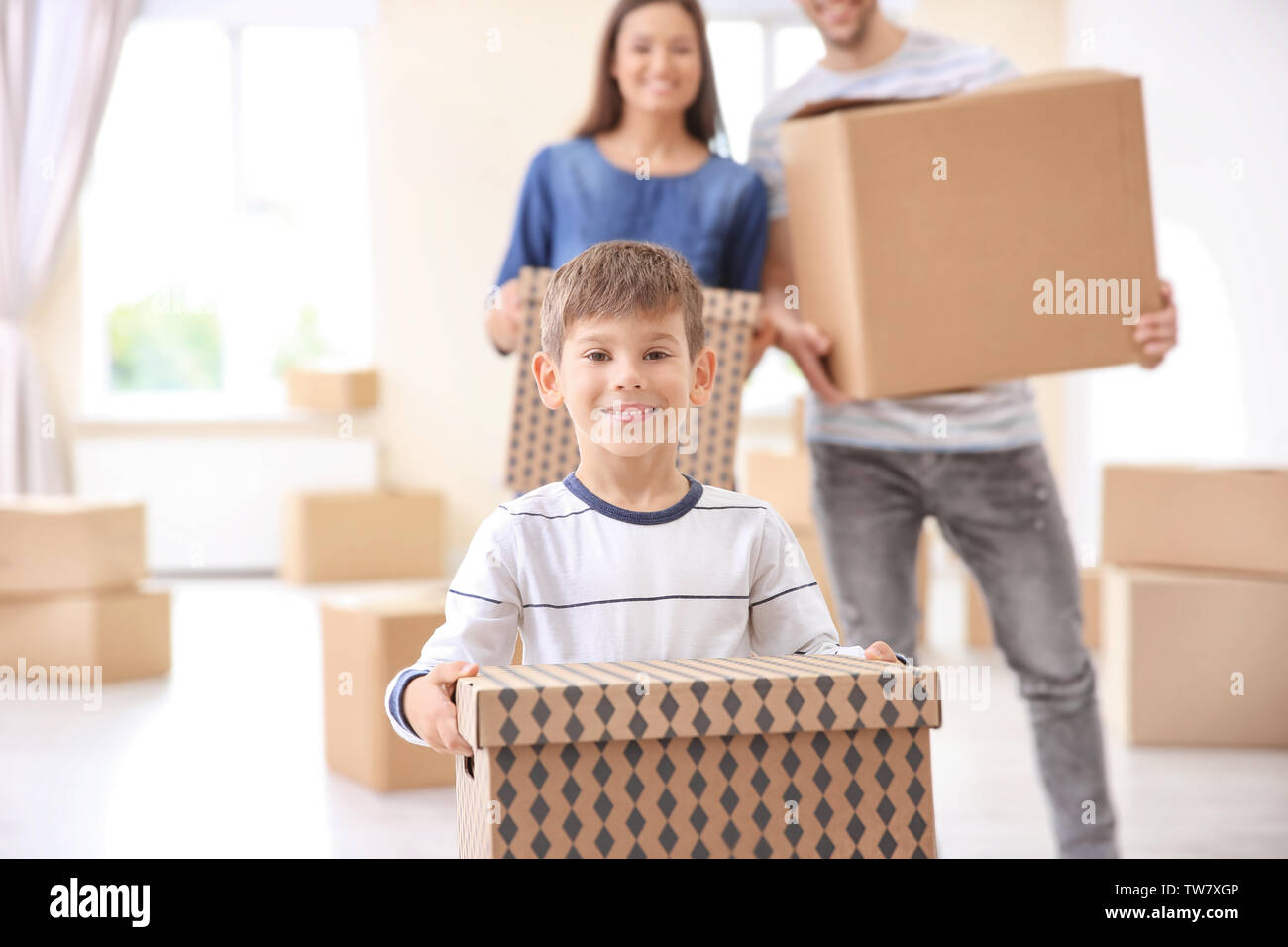 Happy boy and parents in their new home Stock Photo - Alamy