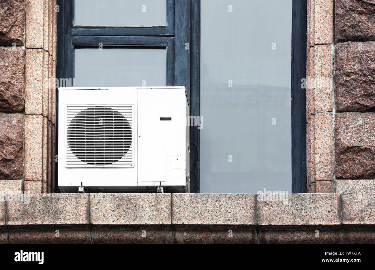 Air conditioner on window sill, outdoors Stock Photo - Alamy
