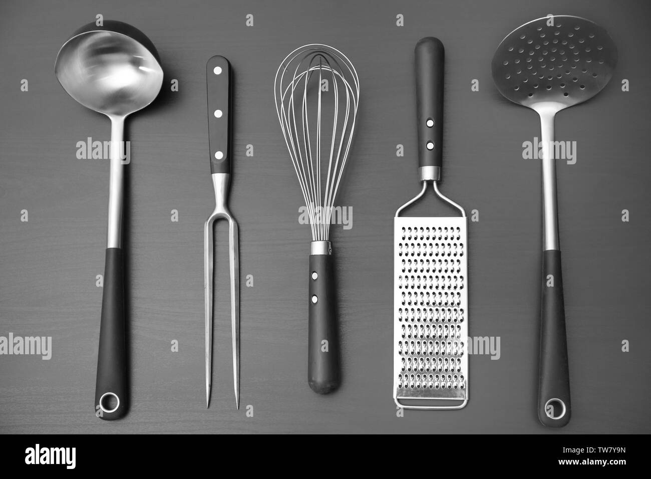 Different kitchen utensils on grey background Stock Photo - Alamy