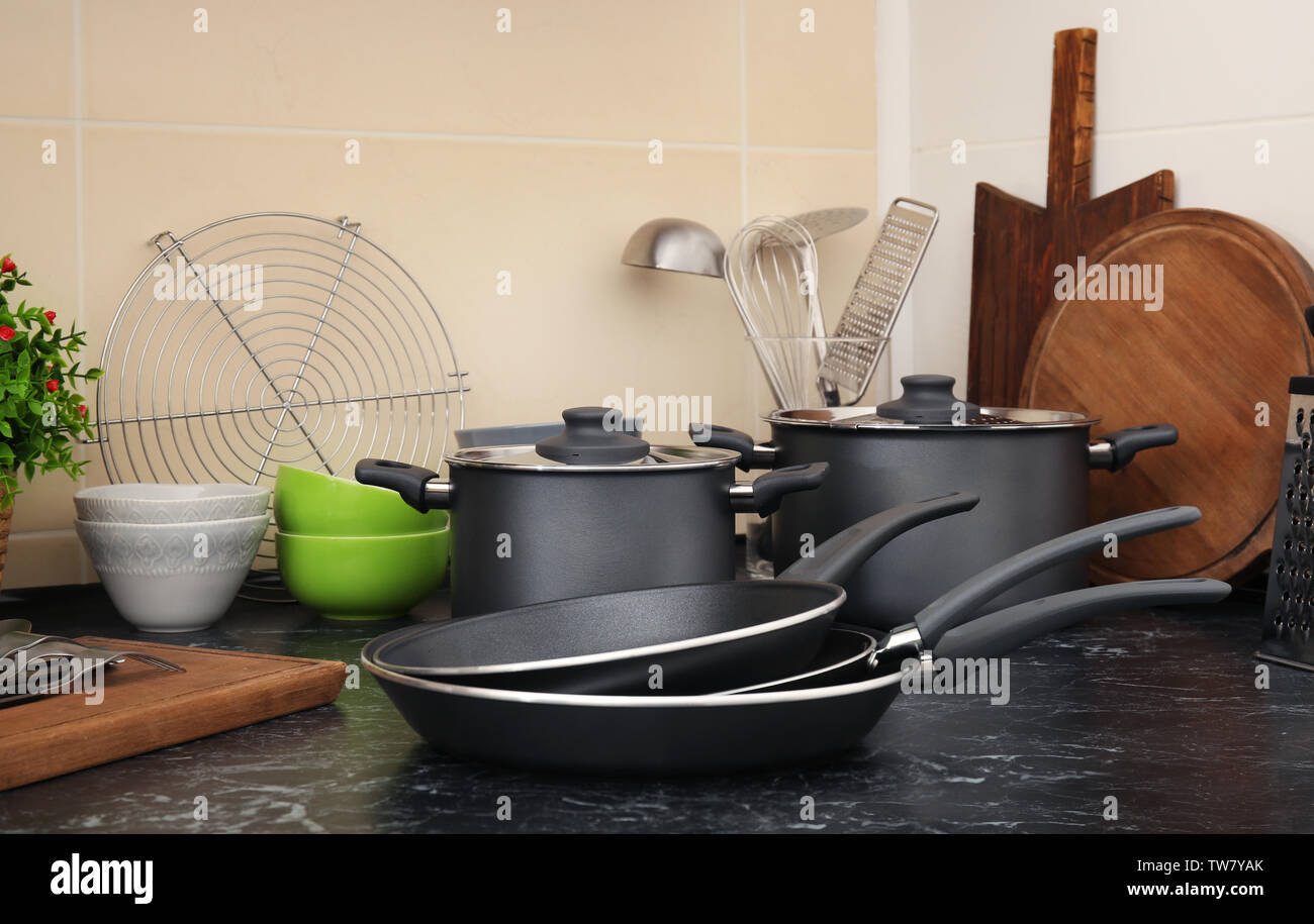 Different cooking utensils on table in kitchen Stock Photo - Alamy