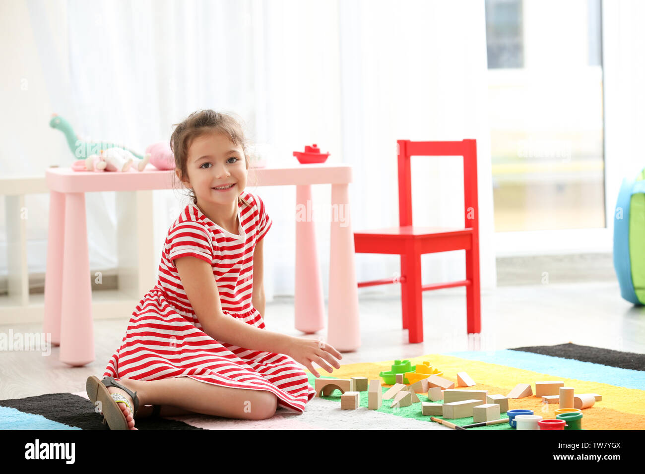 Cute little girl playing with building blocks in kindergarten Stock ...