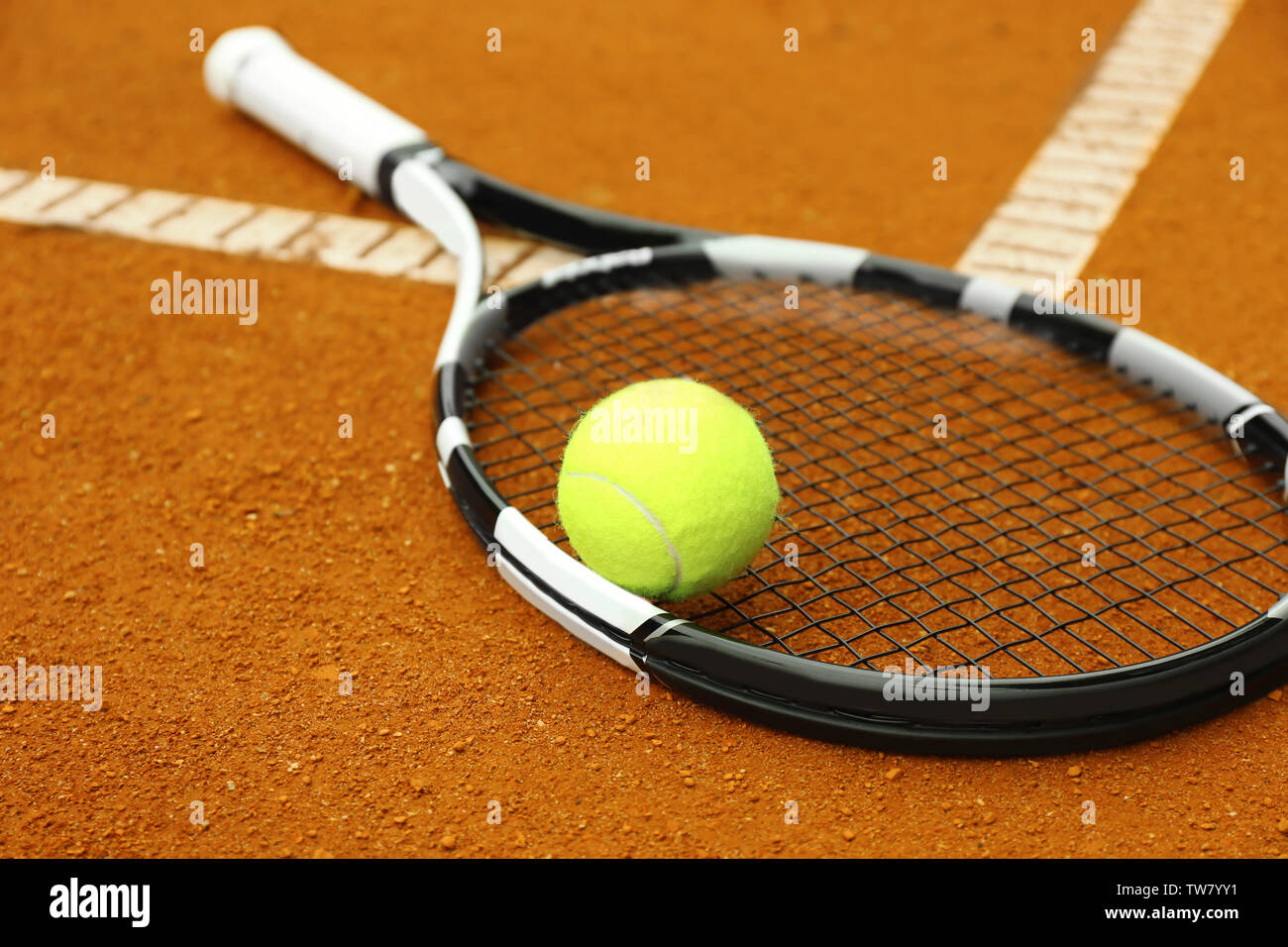 Tennis racket and ball on court Stock Photo - Alamy