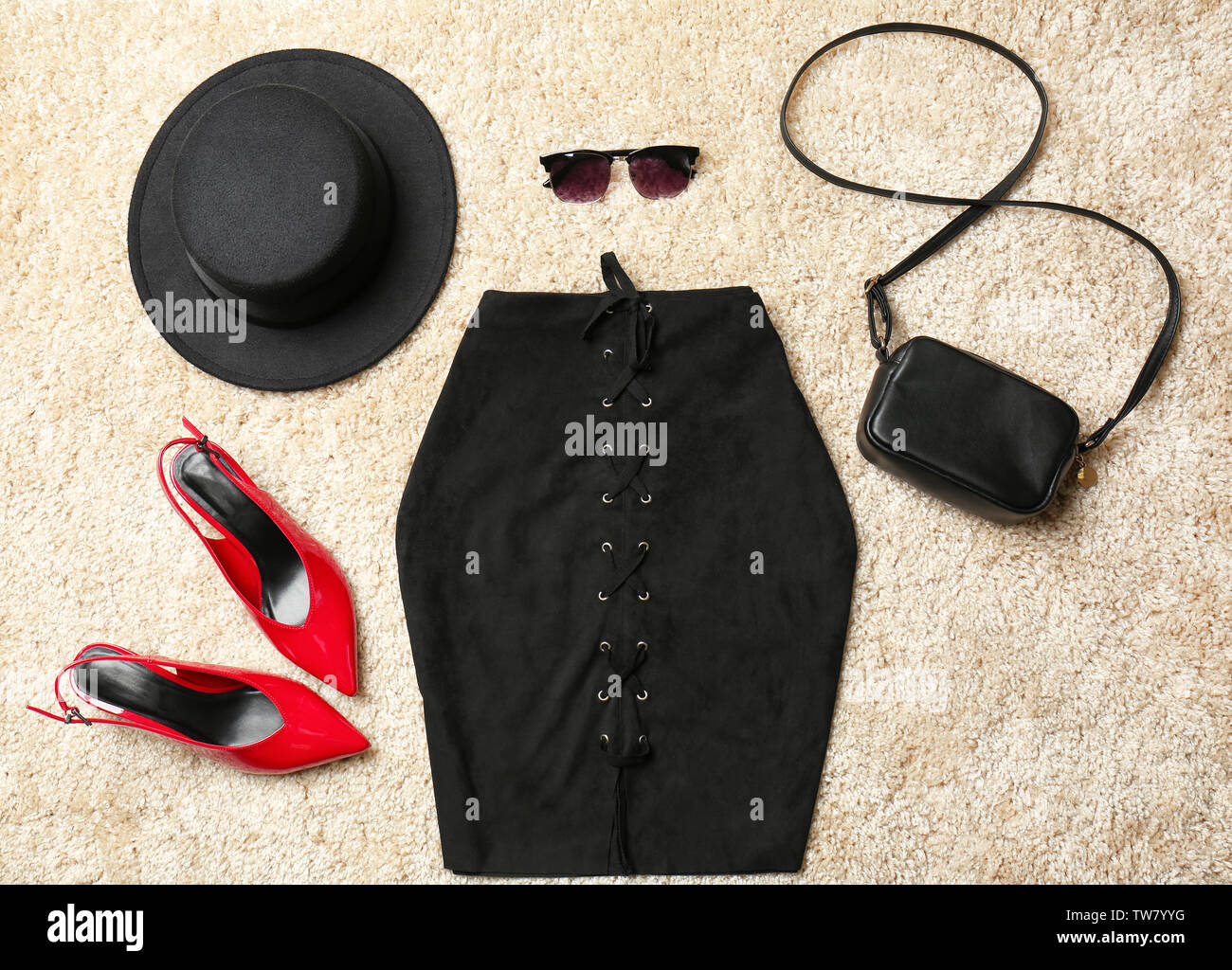 Stylish set of female clothes on carpet Stock Photo - Alamy