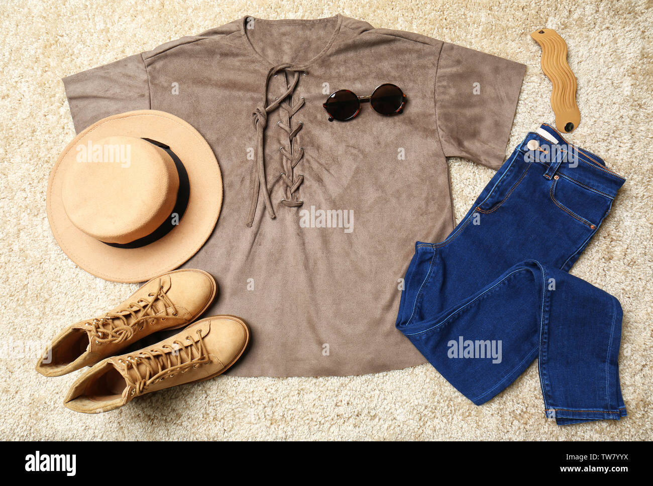 Stylish set of female clothes on carpet Stock Photo - Alamy