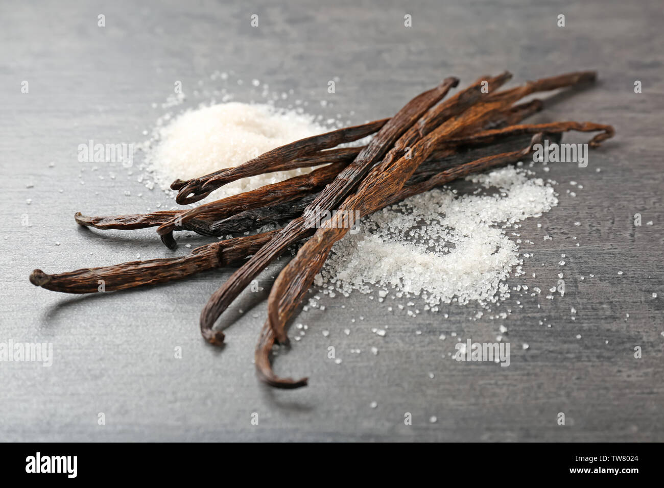 Dried vanilla sticks and sugar on wooden table Stock Photo - Alamy