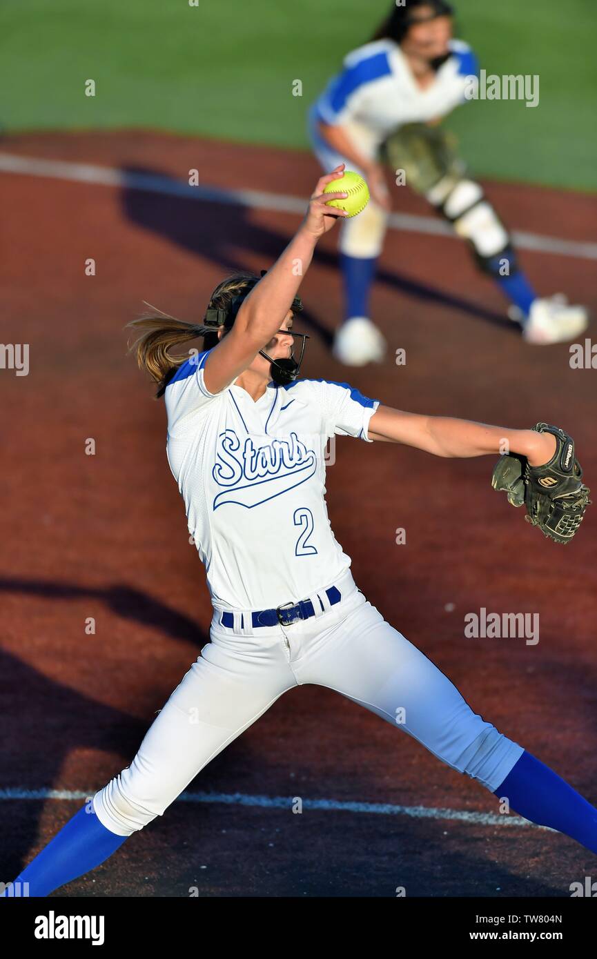 Pitcher in the circle in the wind up prior to releasing a pitch to a ...