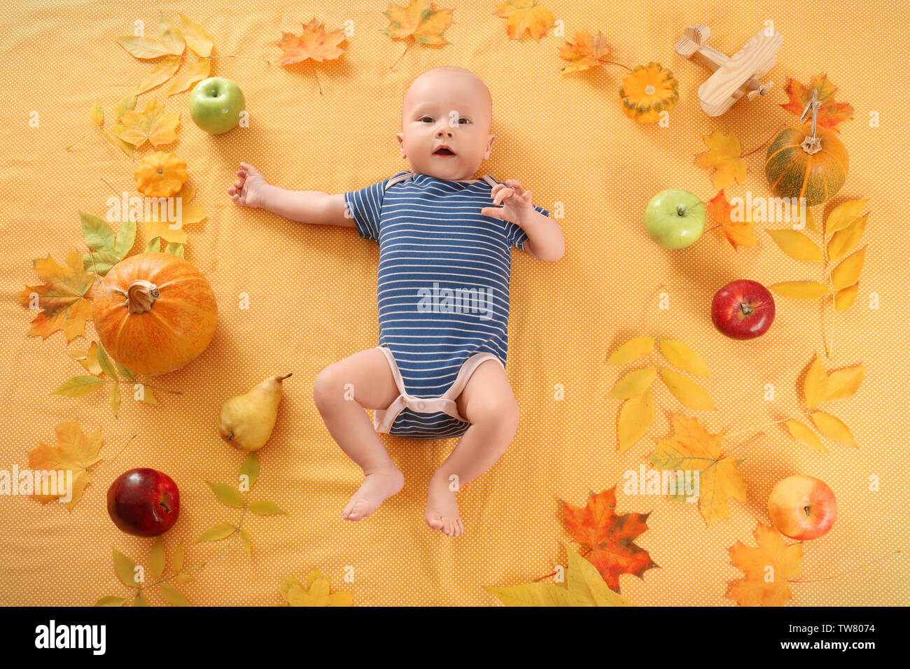 Cute baby, fruits, vegetables and leaves on yellow background Stock ...