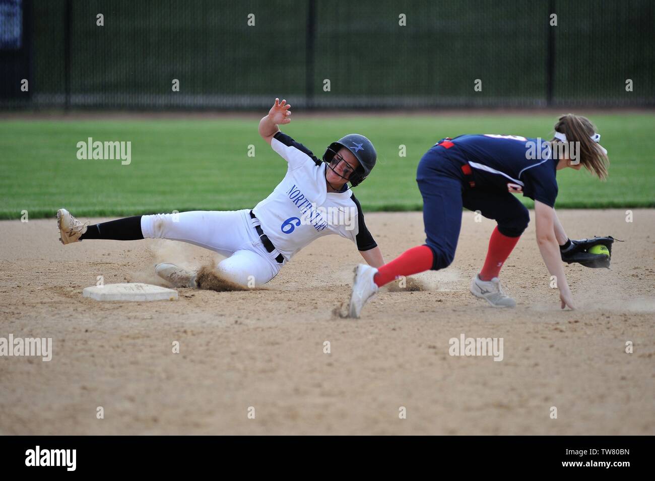 Girl softball player sliding into base hi-res stock photography and ...