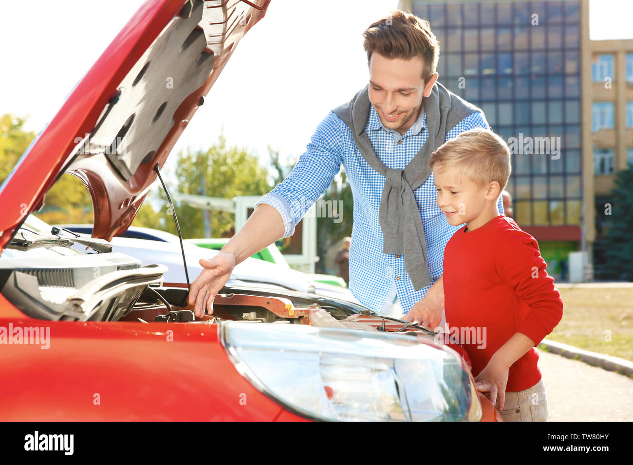 Young father with cute boy repairing car, outdoors Stock Photo - Alamy
