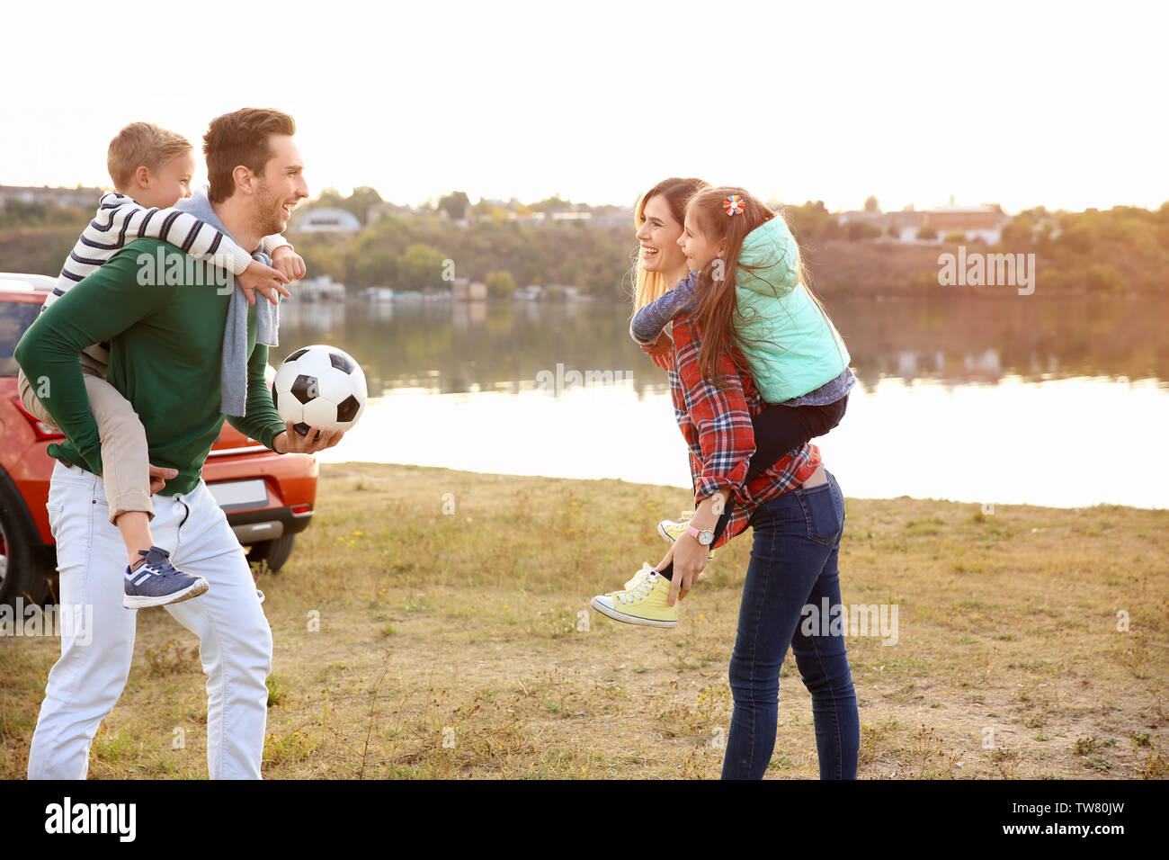 Cute children playing with parents, outdoors Stock Photo - Alamy