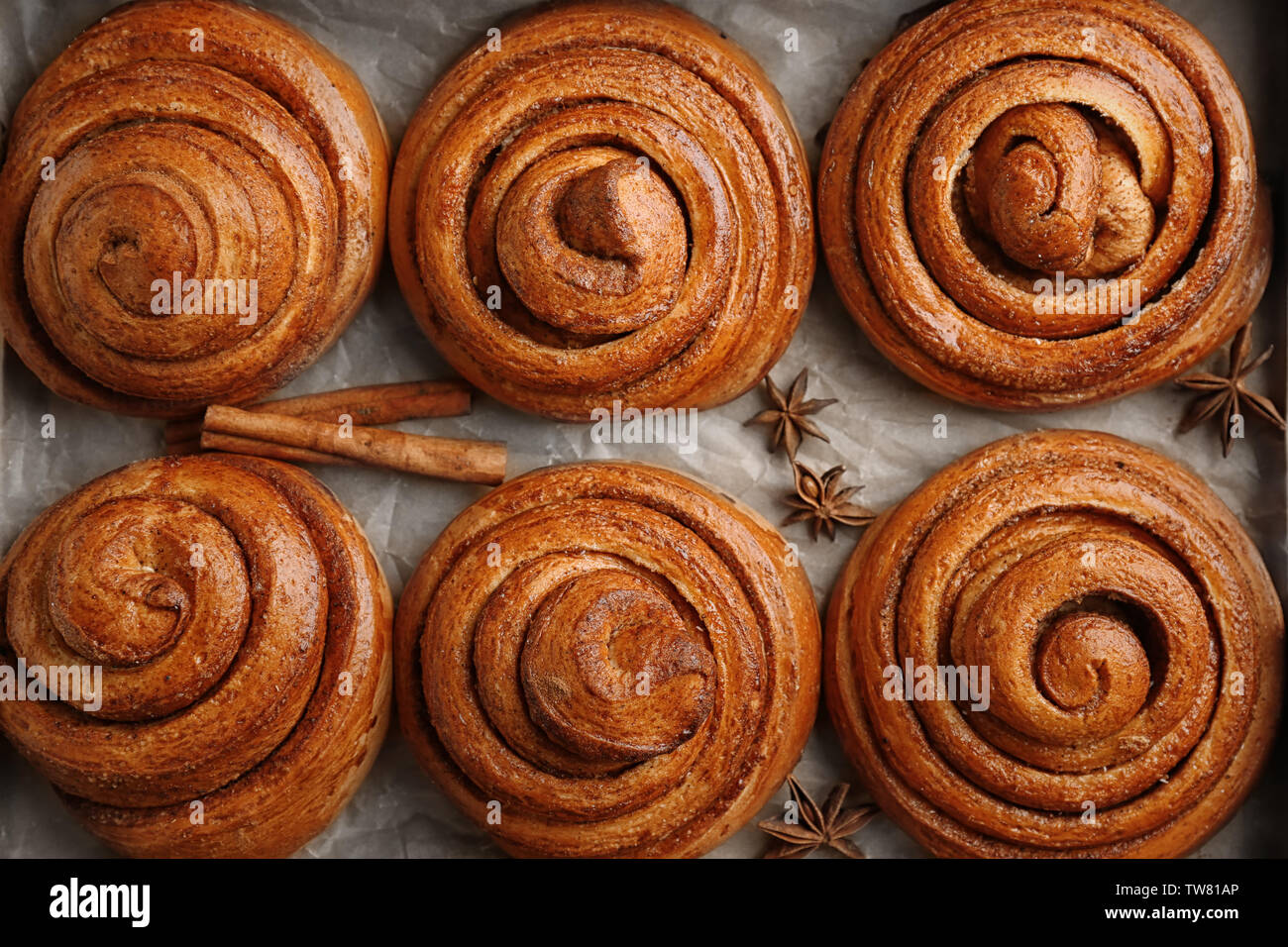 Sweet cinnamon rolls on parchment paper Stock Photo - Alamy