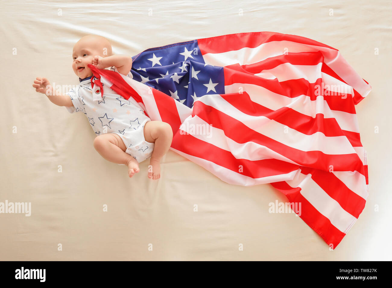 Cute boy with American flag on fabric background Stock Photo - Alamy