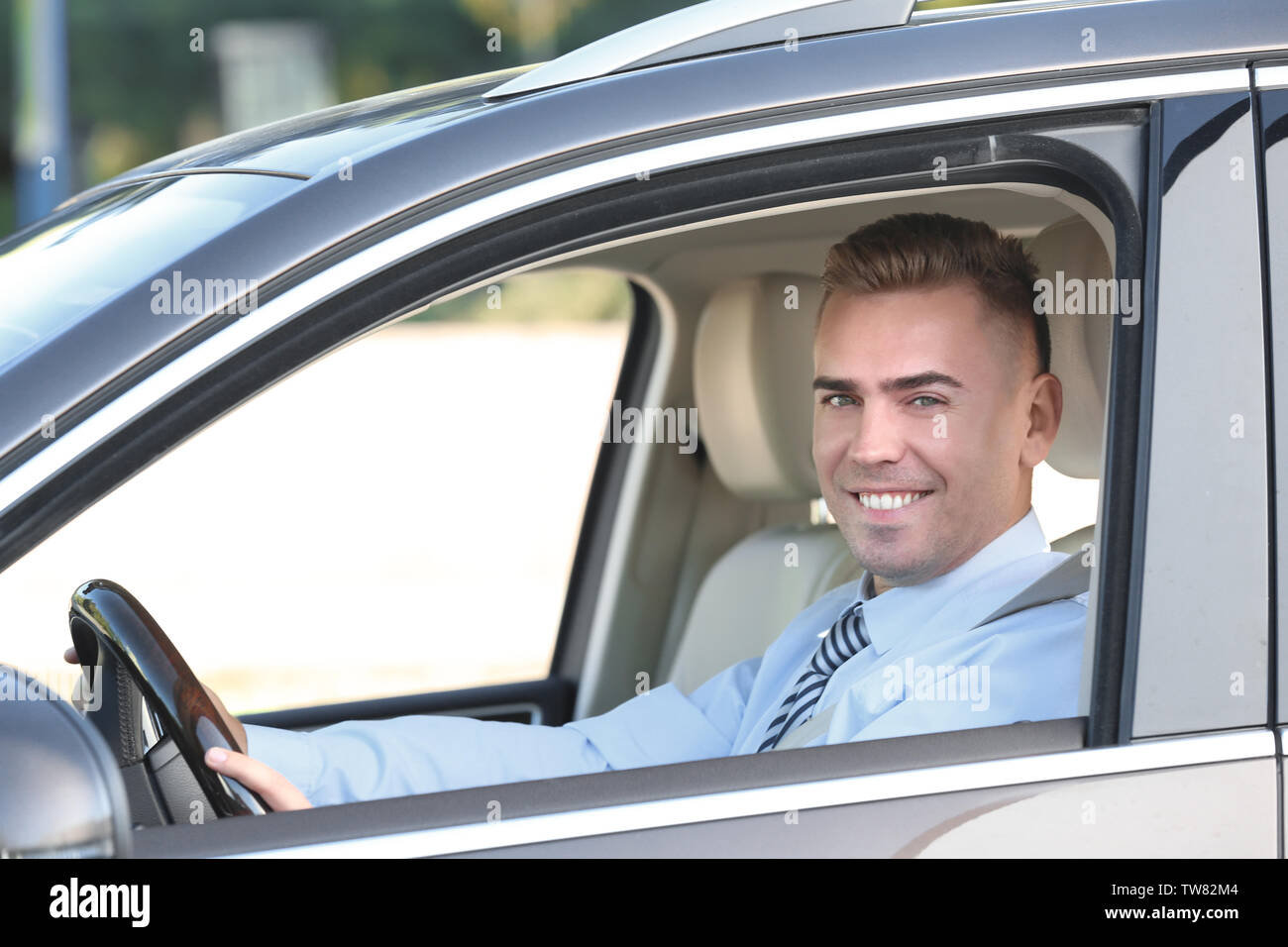 Man in formal wear on driver's seat of car Stock Photo - Alamy