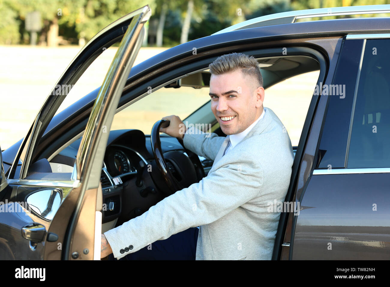 Businessman getting out of car hi-res stock photography and images - Alamy