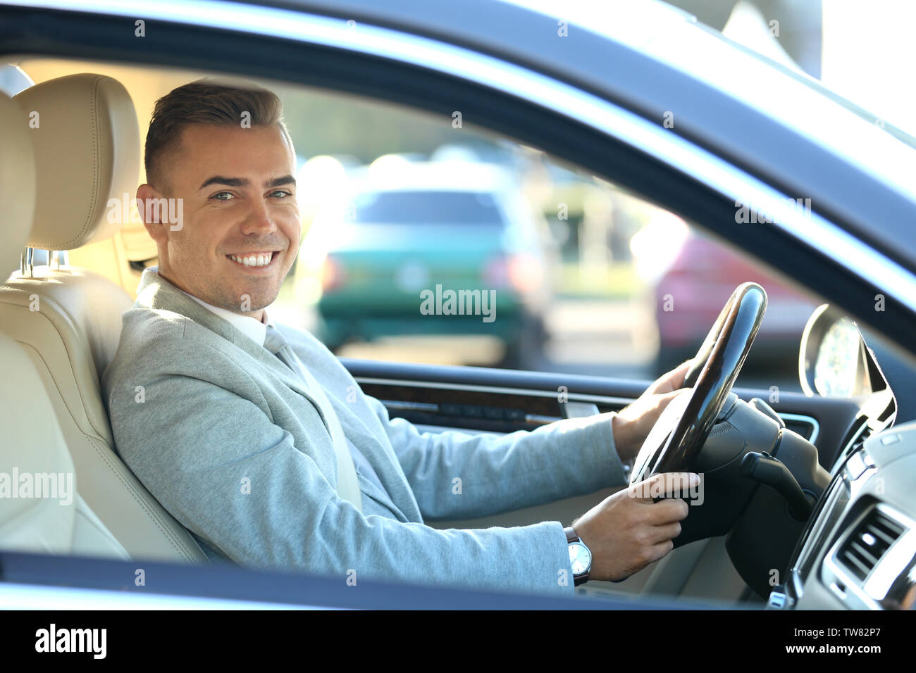 Man in formal wear on driver's seat of car Stock Photo - Alamy