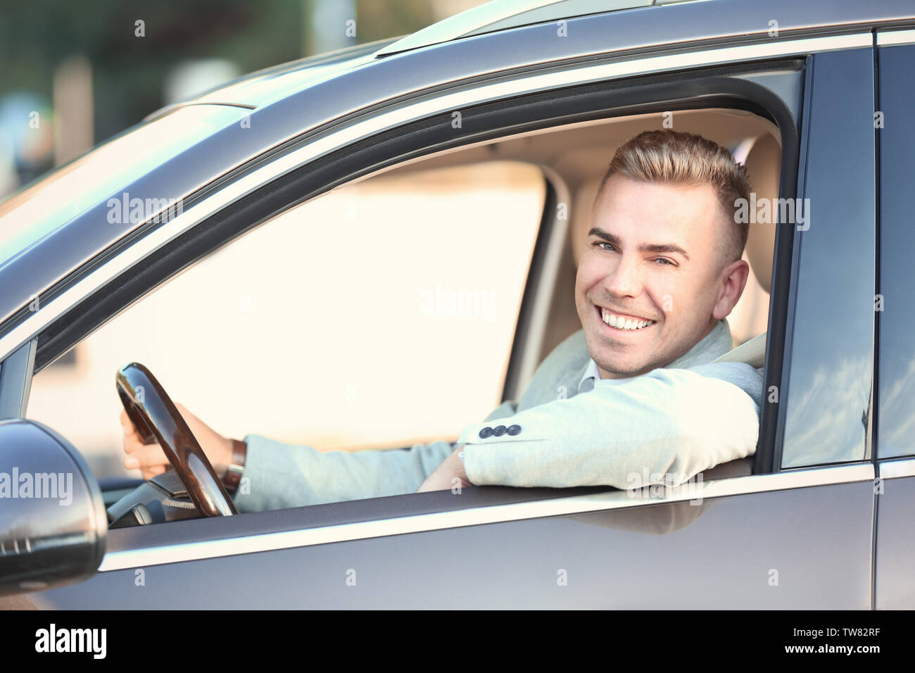 Man in formal wear on driver's seat of car Stock Photo - Alamy