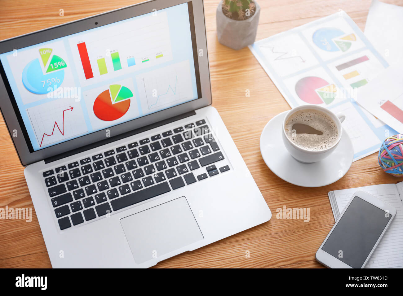 Workplace with laptop and diagrams on screen. Marketing concept Stock ...