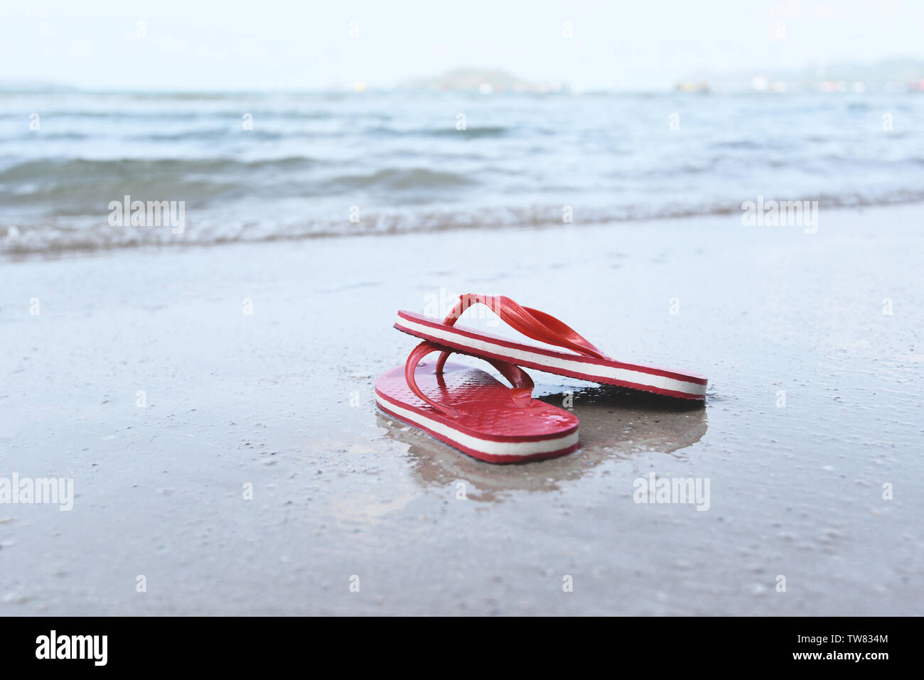 flip flops on beach with wave sandy beach sea at the ocean Stock Photo ...