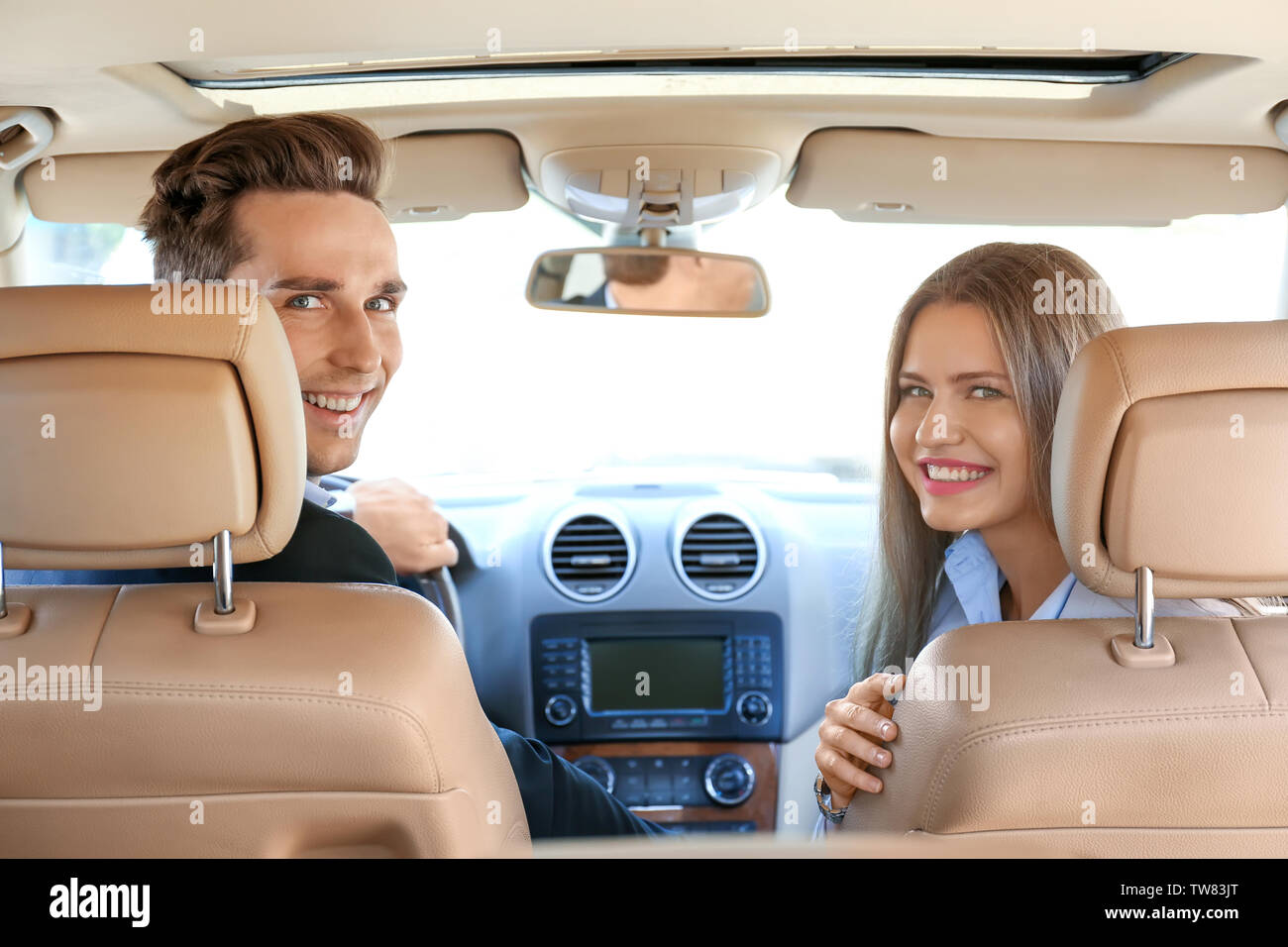 Beautiful young couple in car Stock Photo - Alamy