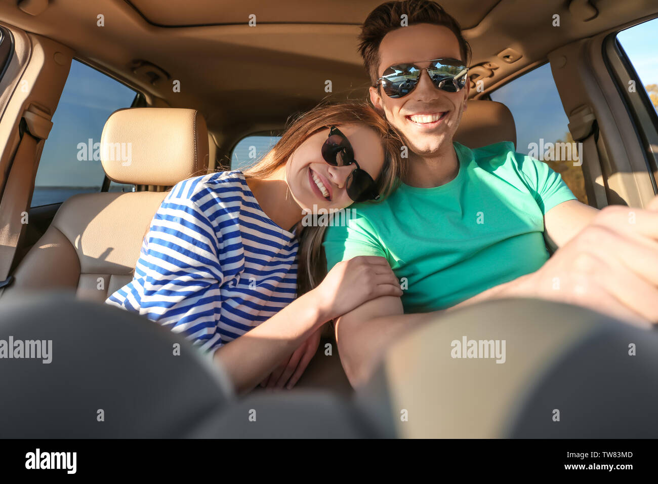 Beautiful young couple in car Stock Photo - Alamy
