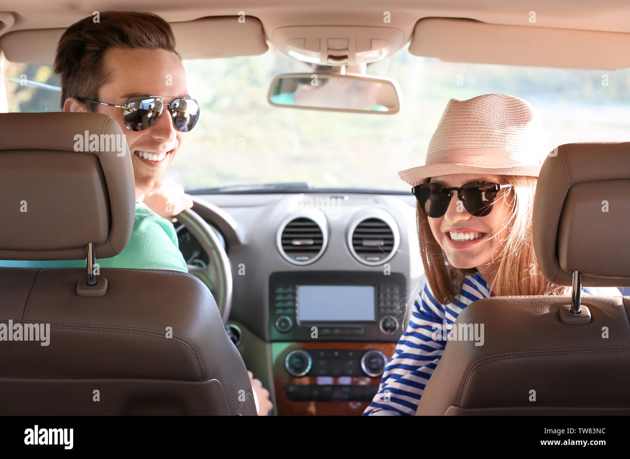 Beautiful young couple in car Stock Photo - Alamy