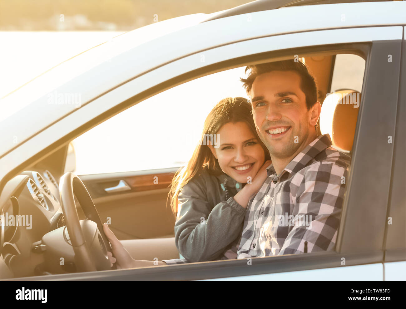 Beautiful young couple in car Stock Photo - Alamy
