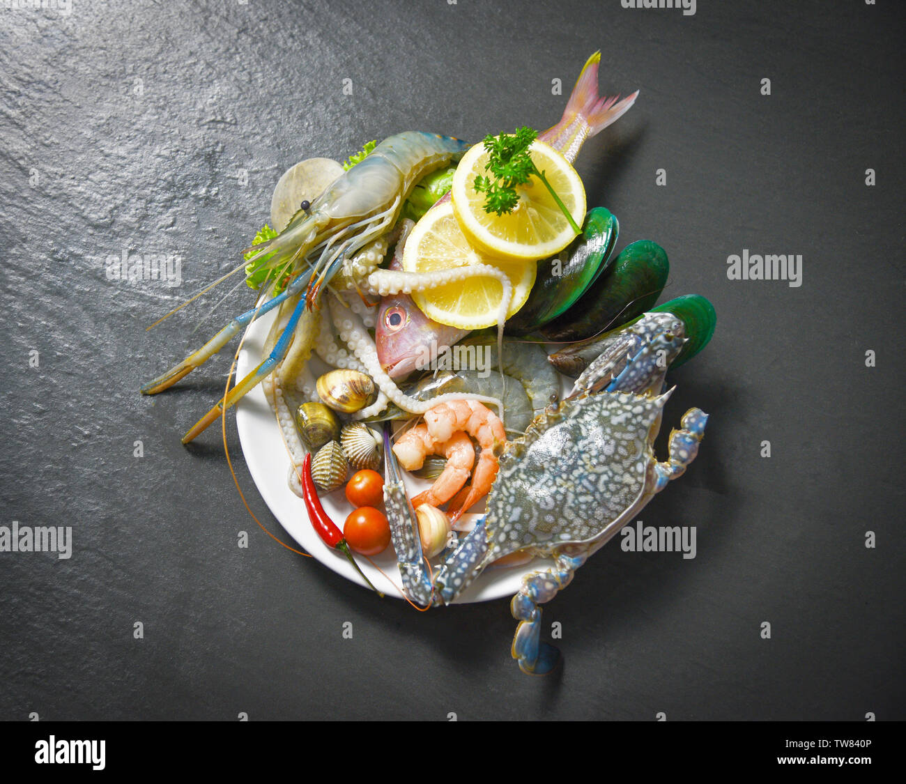 Shellfish seafood plate with shrimps prawns crab shell cockles mussel ...