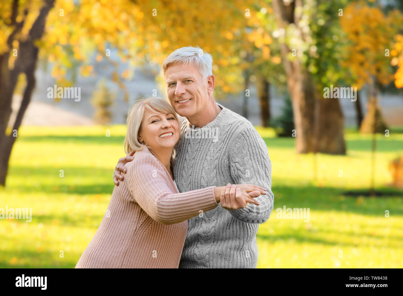 Cute elderly couple dancing in autumn park Stock Photo - Alamy