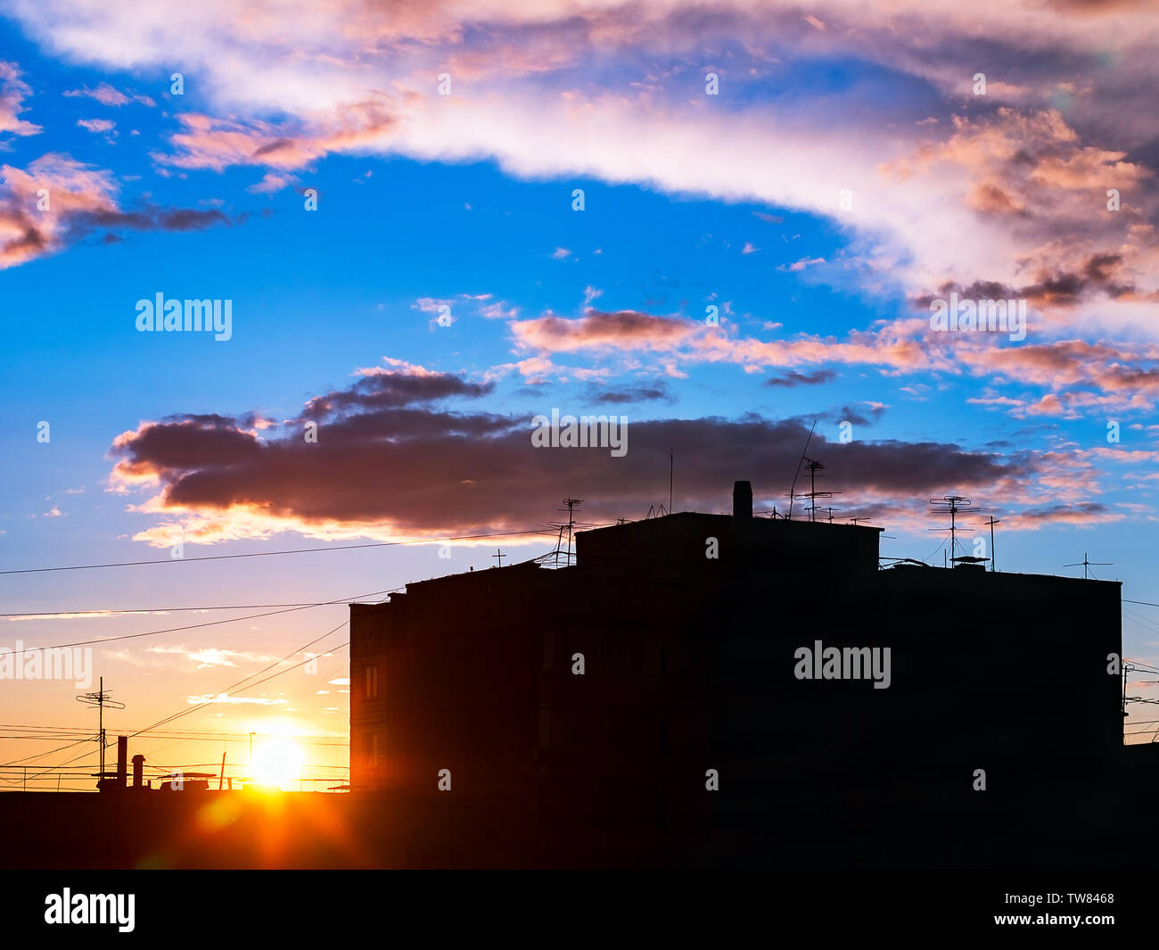 Colorful Sunset over the High-Rise Building Silhouette with Sun Rays ...