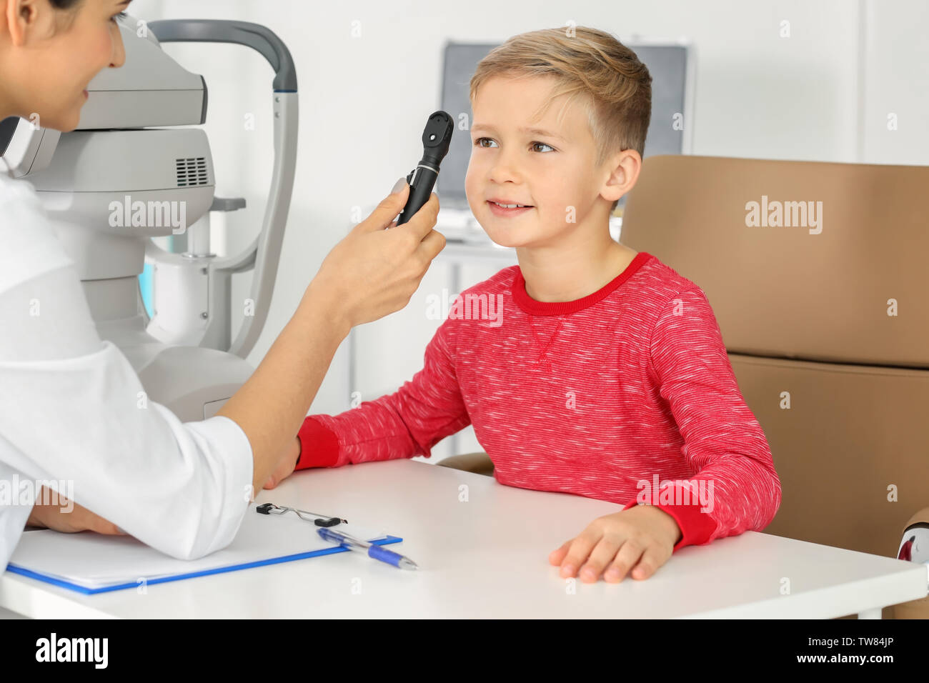 Ophthalmologist inspecting eye fundus of little child in clinic Stock ...
