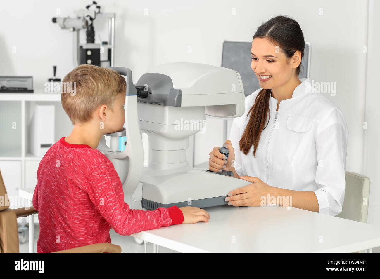Ophthalmologist measuring intraocular pressure of little child in ...