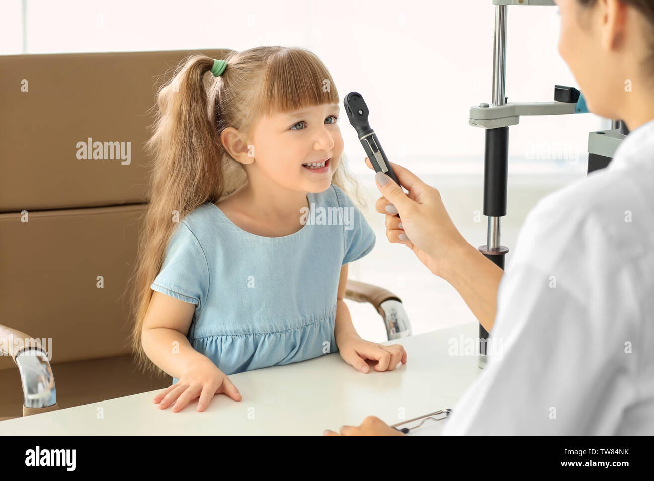Ophthalmologist inspecting eye fundus of little child in clinic Stock ...