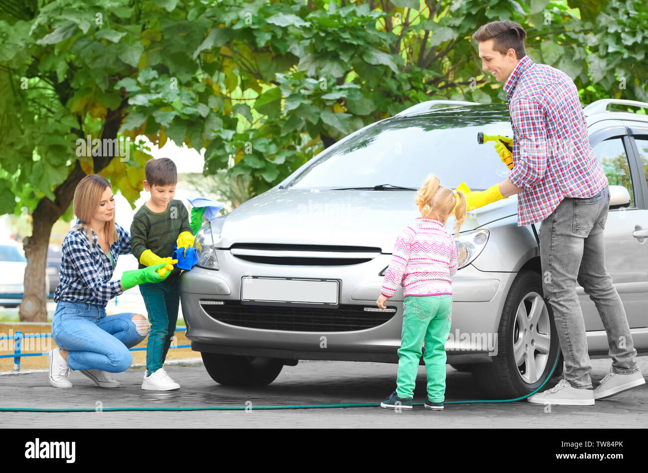 Happy family washing car outdoors Stock Photo - Alamy