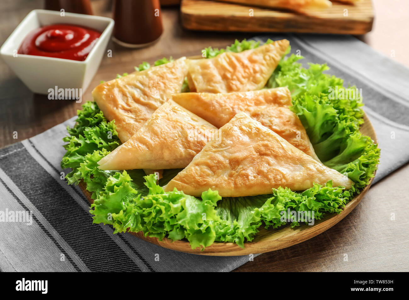 Plate with delicious samosas on table Stock Photo - Alamy